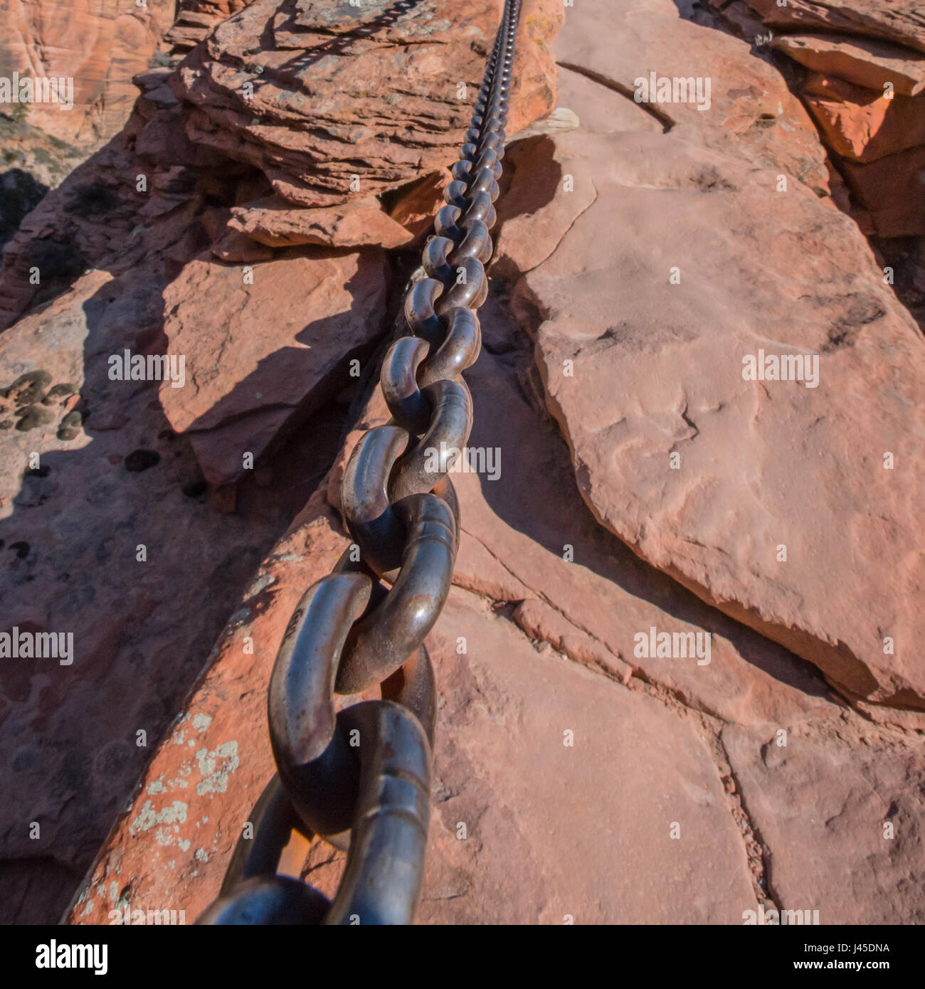 Hiking Chain Along Slick Rock Trail on Narrow Cliff Stock Photo - Alamy