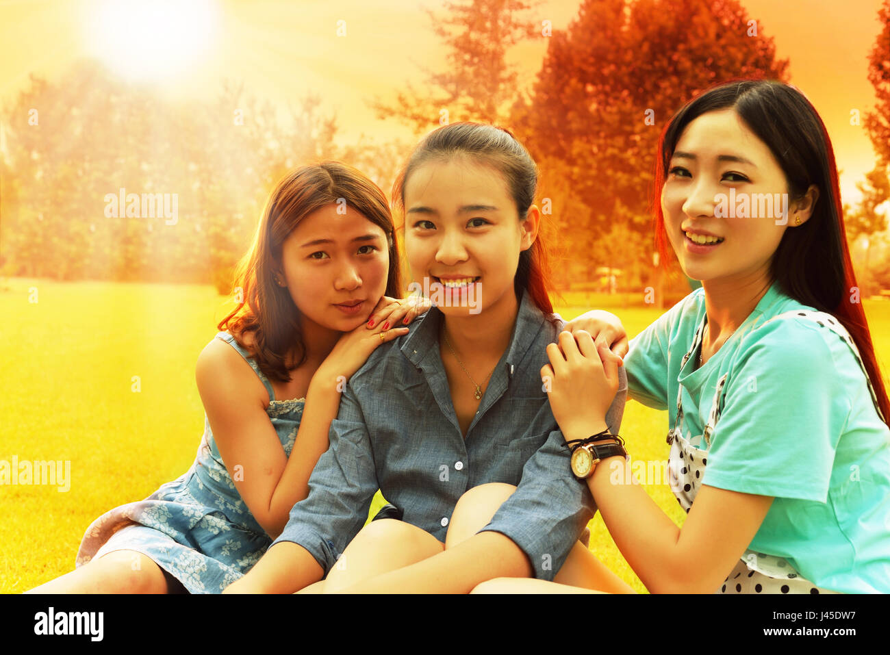 Three girls with photo. Sunny in the morning time Stock Photo - Alamy