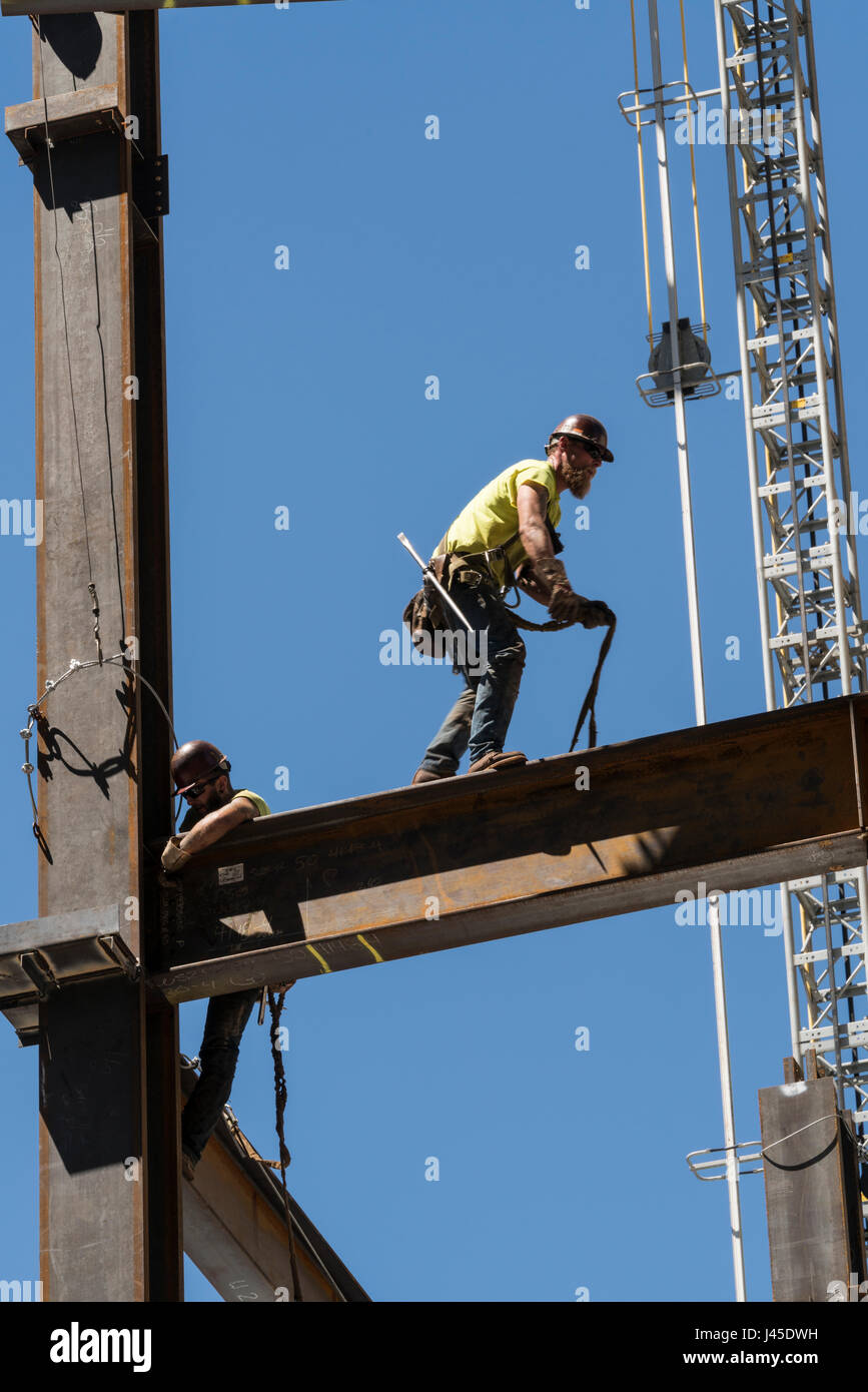 United States, Washington, Seattle, Workers putting up iron frame while ...