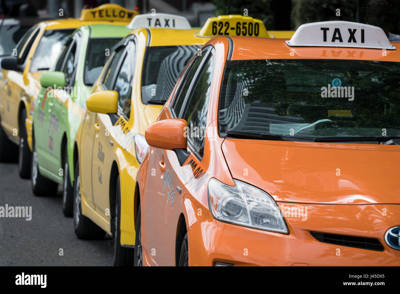 Taxis lined up waiting for fares Stock Photo - Alamy
