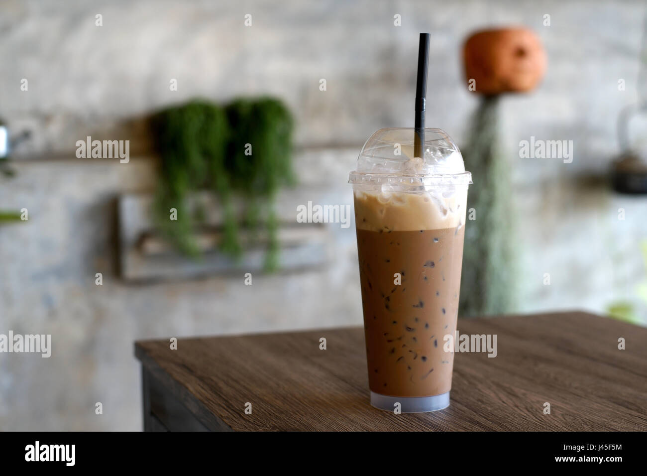 ice coffee in takeaway cup on wooden table Stock Photo - Alamy