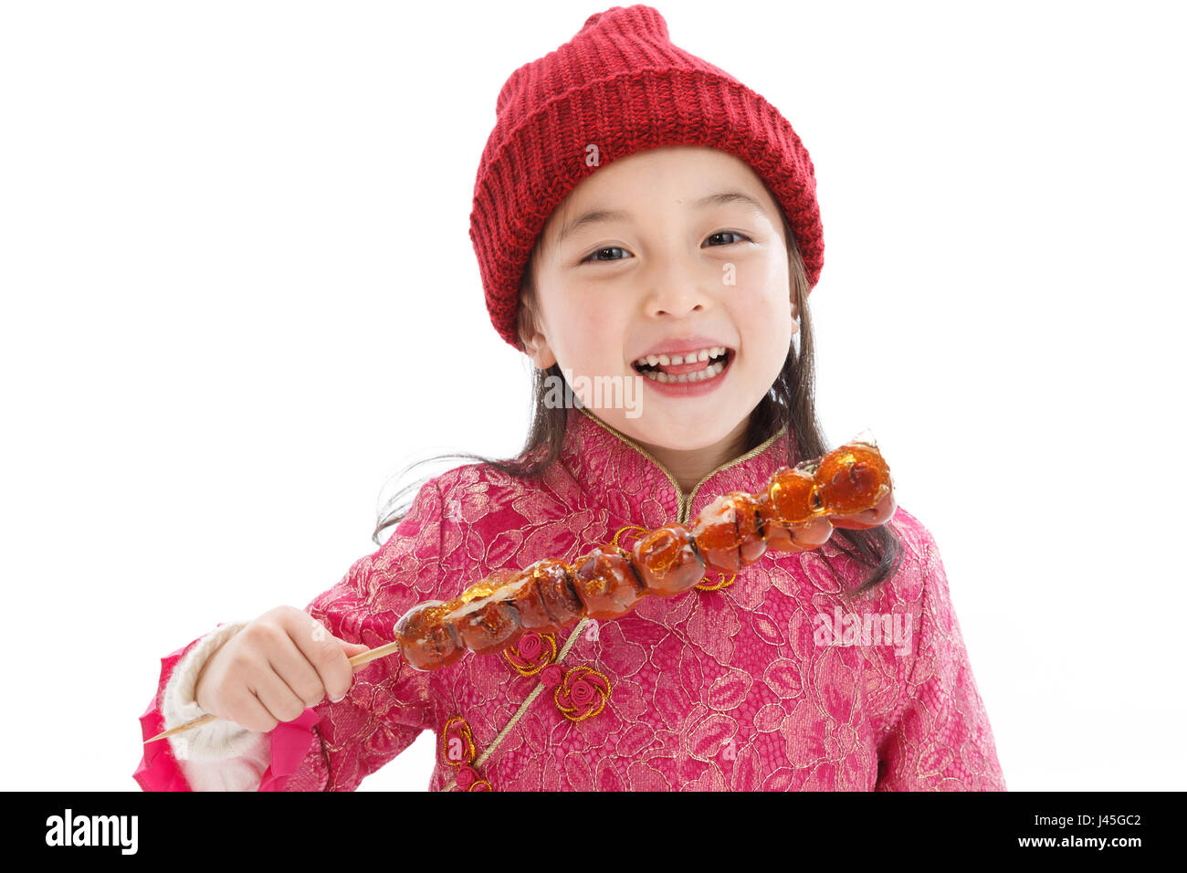 Happy little girl eating Tomatoes on sticks Stock Photo - Alamy