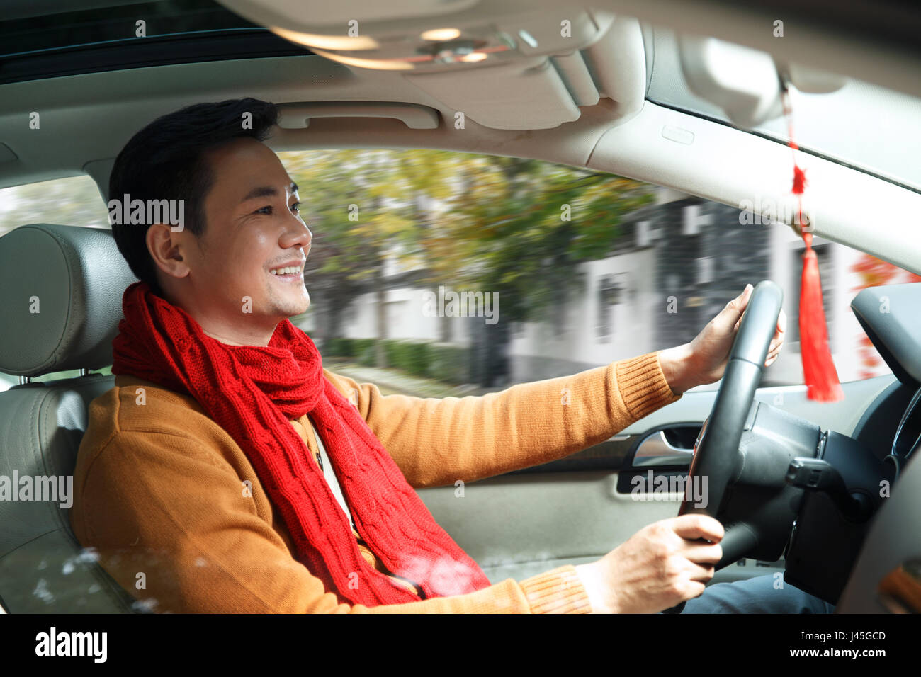 Young chinese man driving car hi-res stock photography and images - Alamy