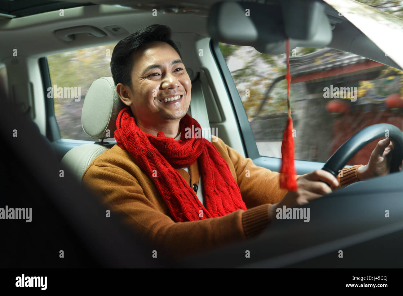 Young chinese man driving car hi-res stock photography and images - Alamy