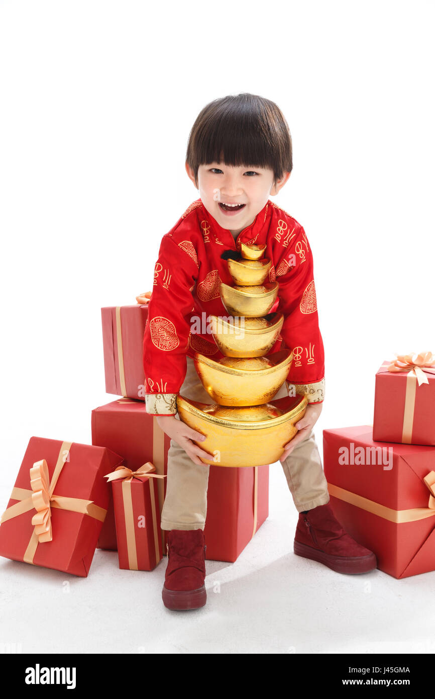 Cute little boy holding gold Stock Photo - Alamy