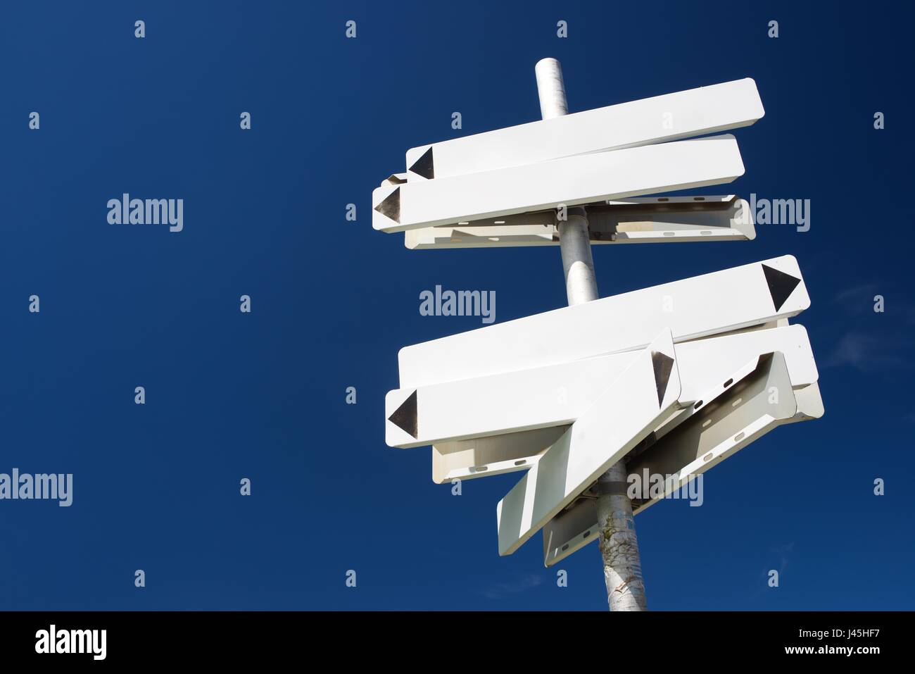 Directional signals in a pole with blue sky Stock Photo - Alamy