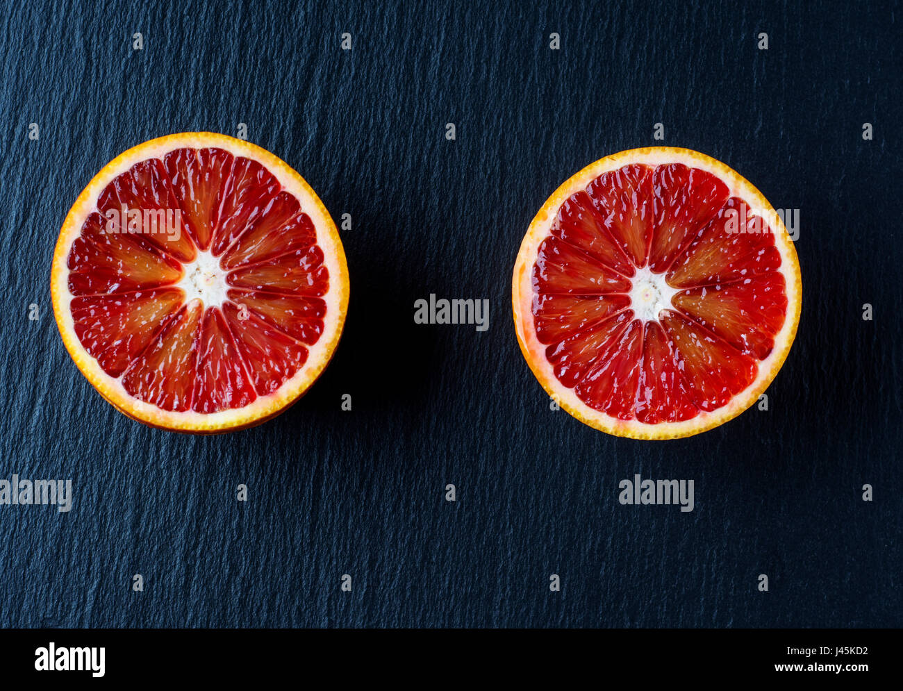 Bloody Oranges on a black background Stock Photo - Alamy