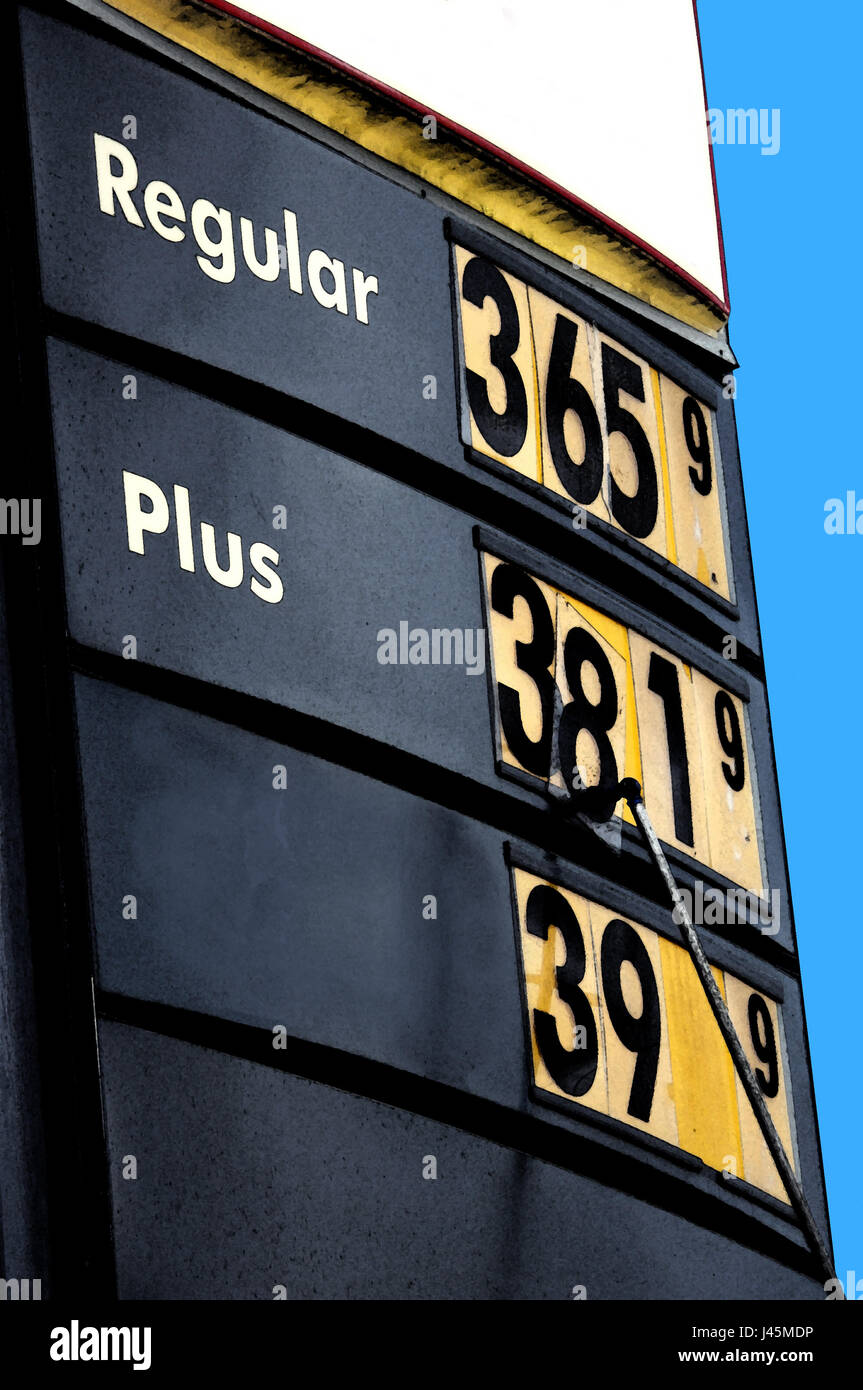 Gasoline station worker changes the price of fuel. He is placing the ...