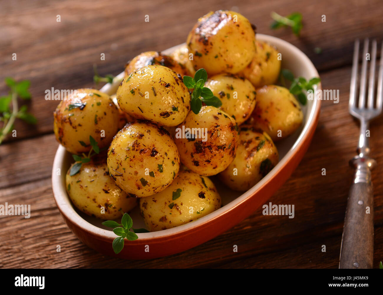 Roasted young potatoes Stock Photo - Alamy