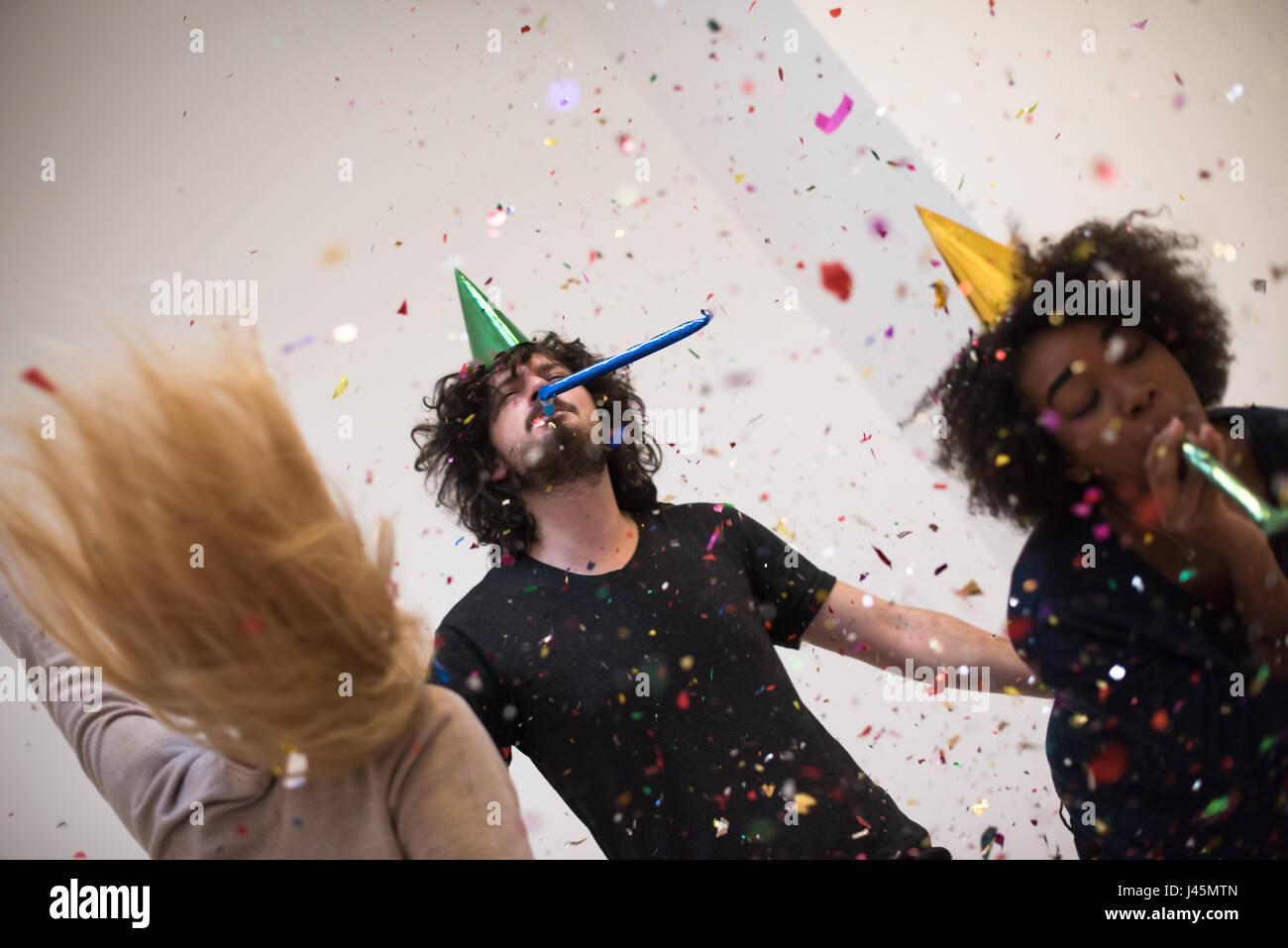 confetti party Multiethnics happy young people group celebrating new ...