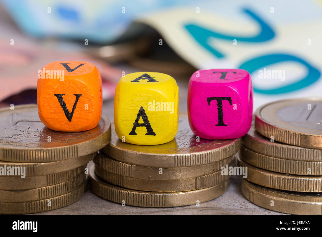 VAT letter cubes on coins concept Stock Photo - Alamy