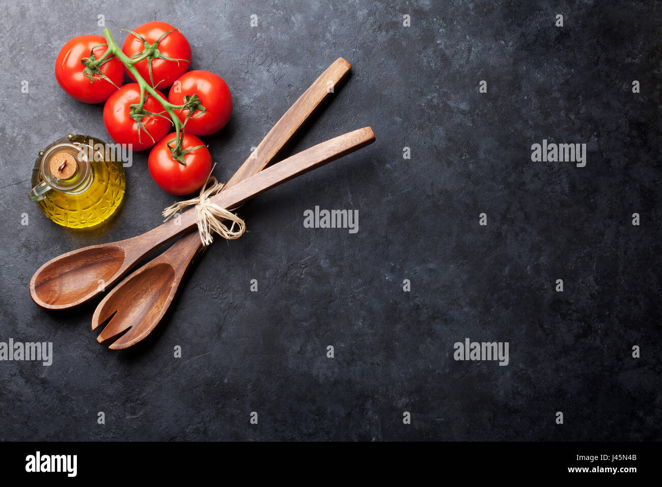Cooking ingredients and utensils on stone table. Top view with space ...
