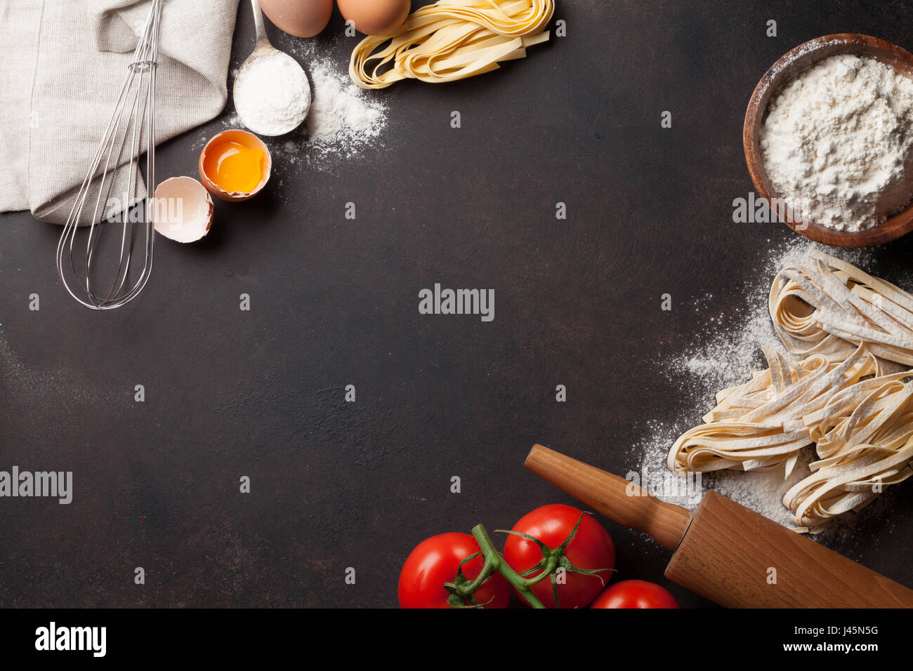 Pasta cooking ingredients on kitchen table. Top view with space for ...