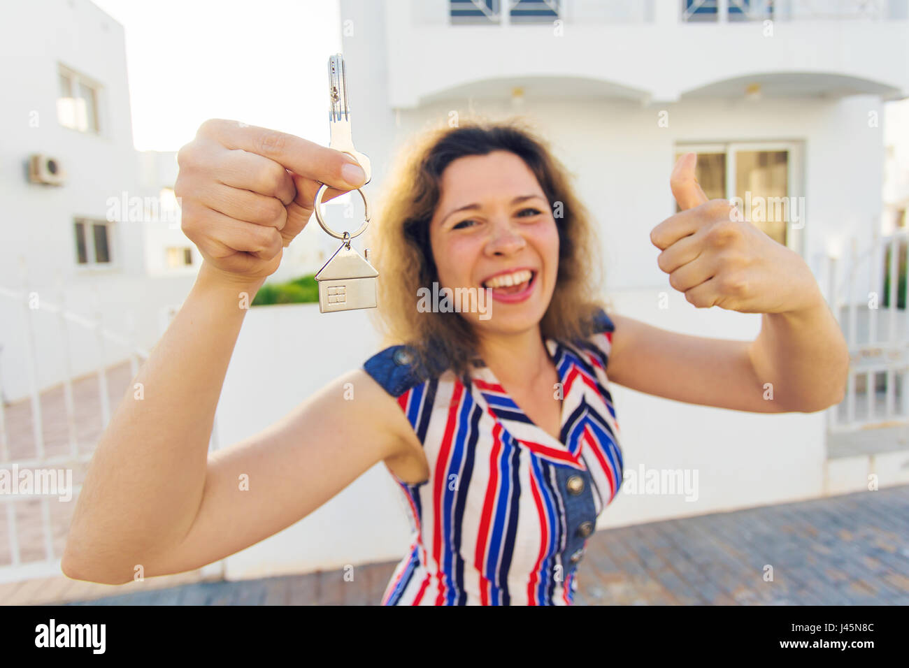 Happy house owner or renter showing keys and looking at you Stock Photo ...