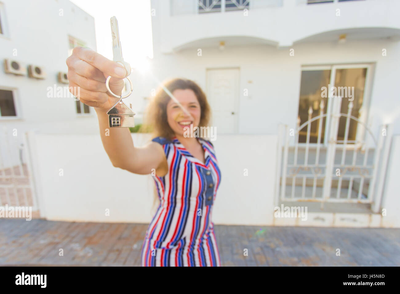 Happy house owner or renter showing keys and looking at you Stock Photo ...