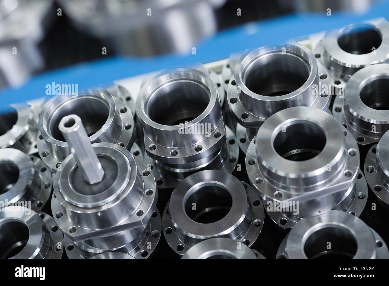 Close-up of a set of metallic gears and parts produced in metal factory ...