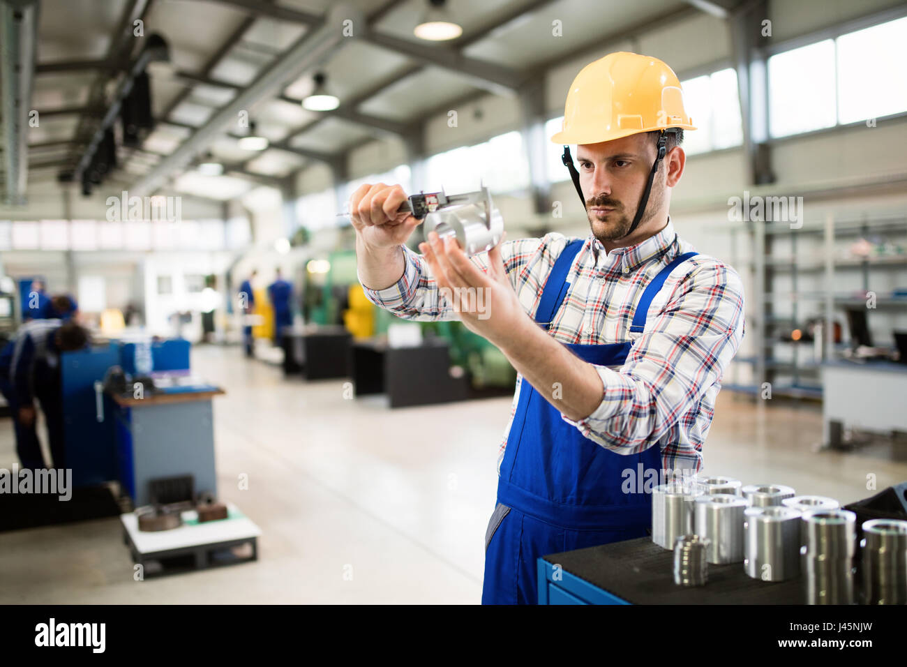 Supervisor doing quality control and pruduction check in metal factory ...