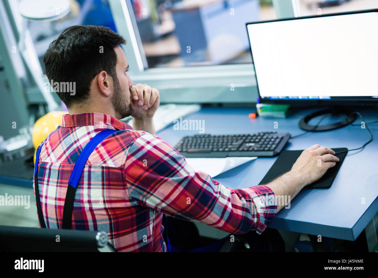 Operator works in a control room in metal industry factory Stock Photo ...