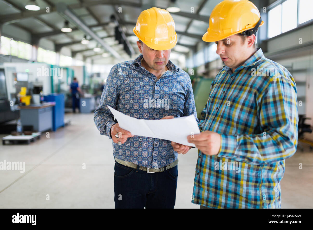Team Of Engineers Having Discussion In Metal Industries Factory Stock ...