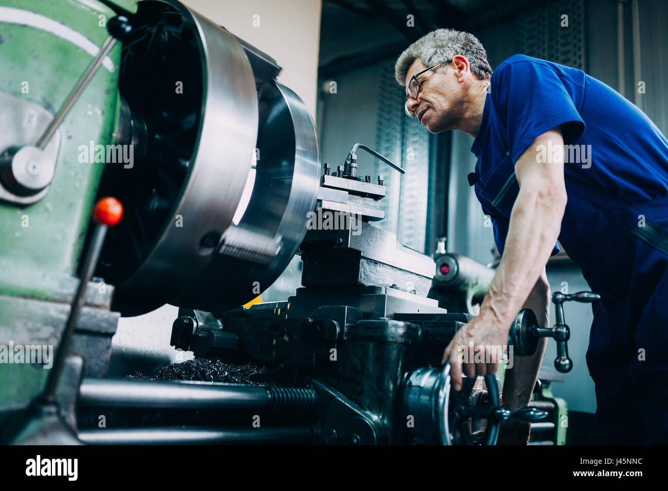 Tired overworked worker falls asleep during working hours in factory ...