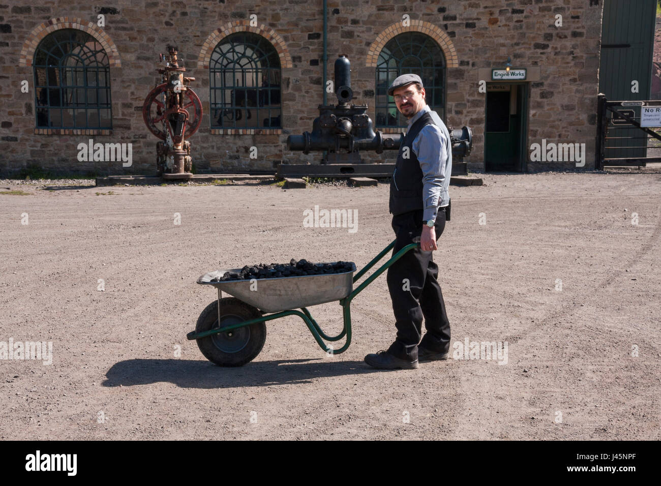 A man wheeling a barrow full of coal at the Beamish Museum,England,UK ...