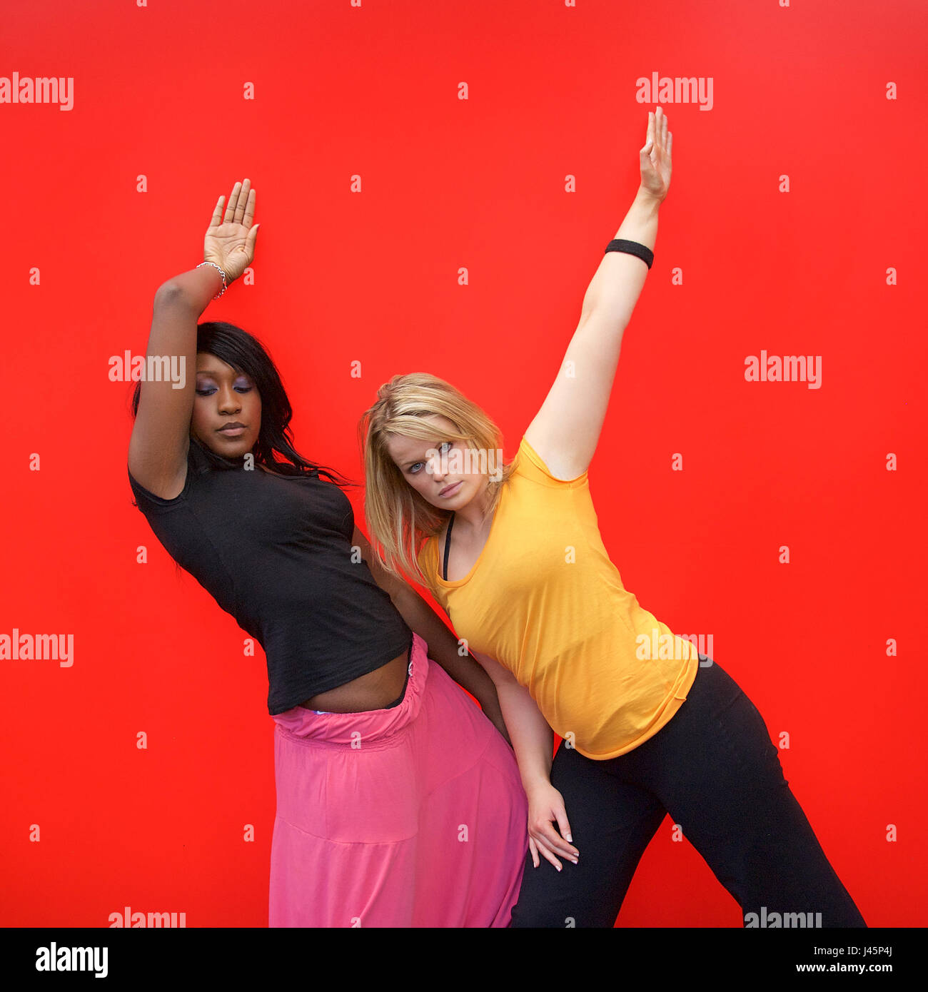 Two modern dancers against a red background Stock Photo - Alamy