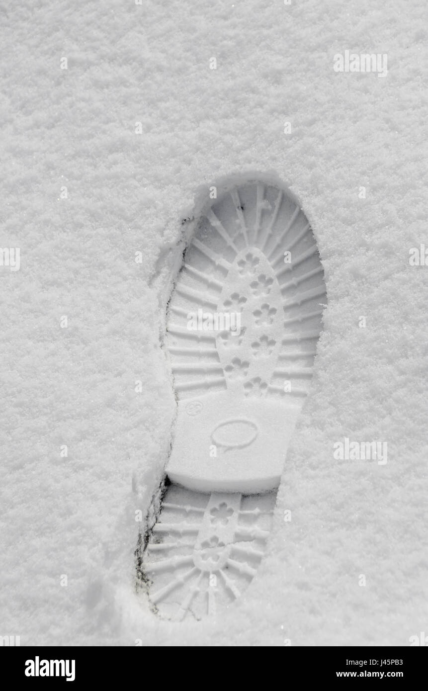 Footsteps in the snow, boot mark close up outdoor Stock Photo - Alamy