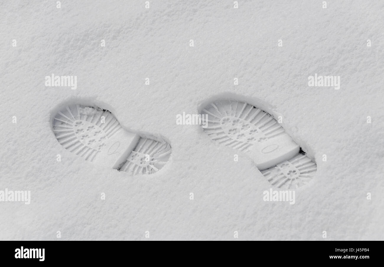 Footsteps in the snow, boot mark close up outdoor Stock Photo - Alamy