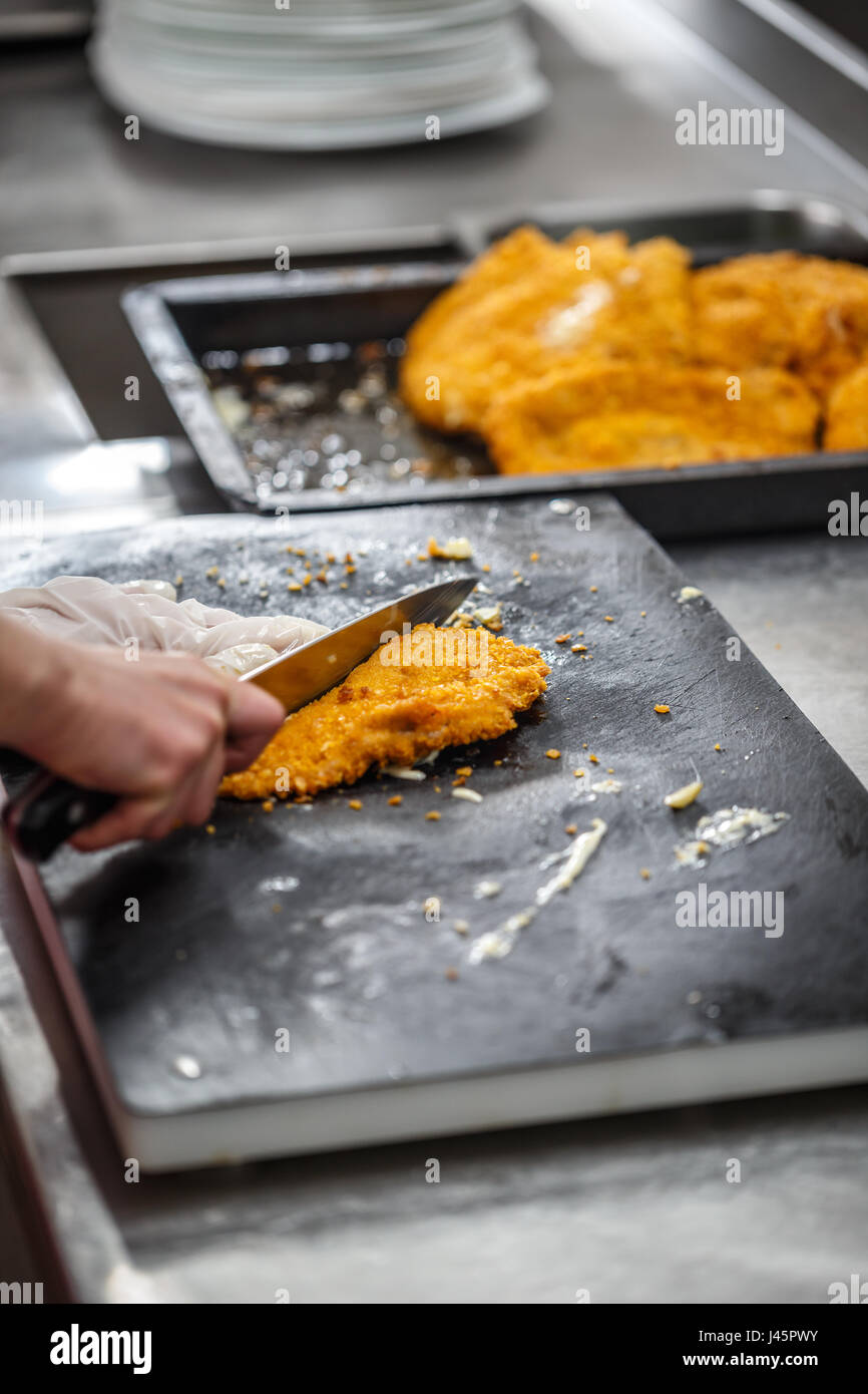 Chef cut breaded german weiner schnitzel Stock Photo - Alamy