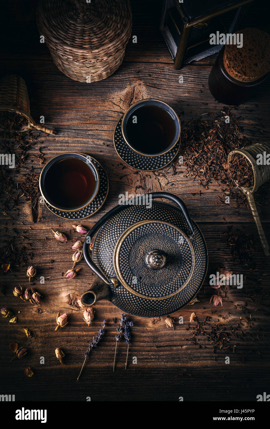 Top view of herbal tea prepared in vintage cast iron teapot on rustic ...