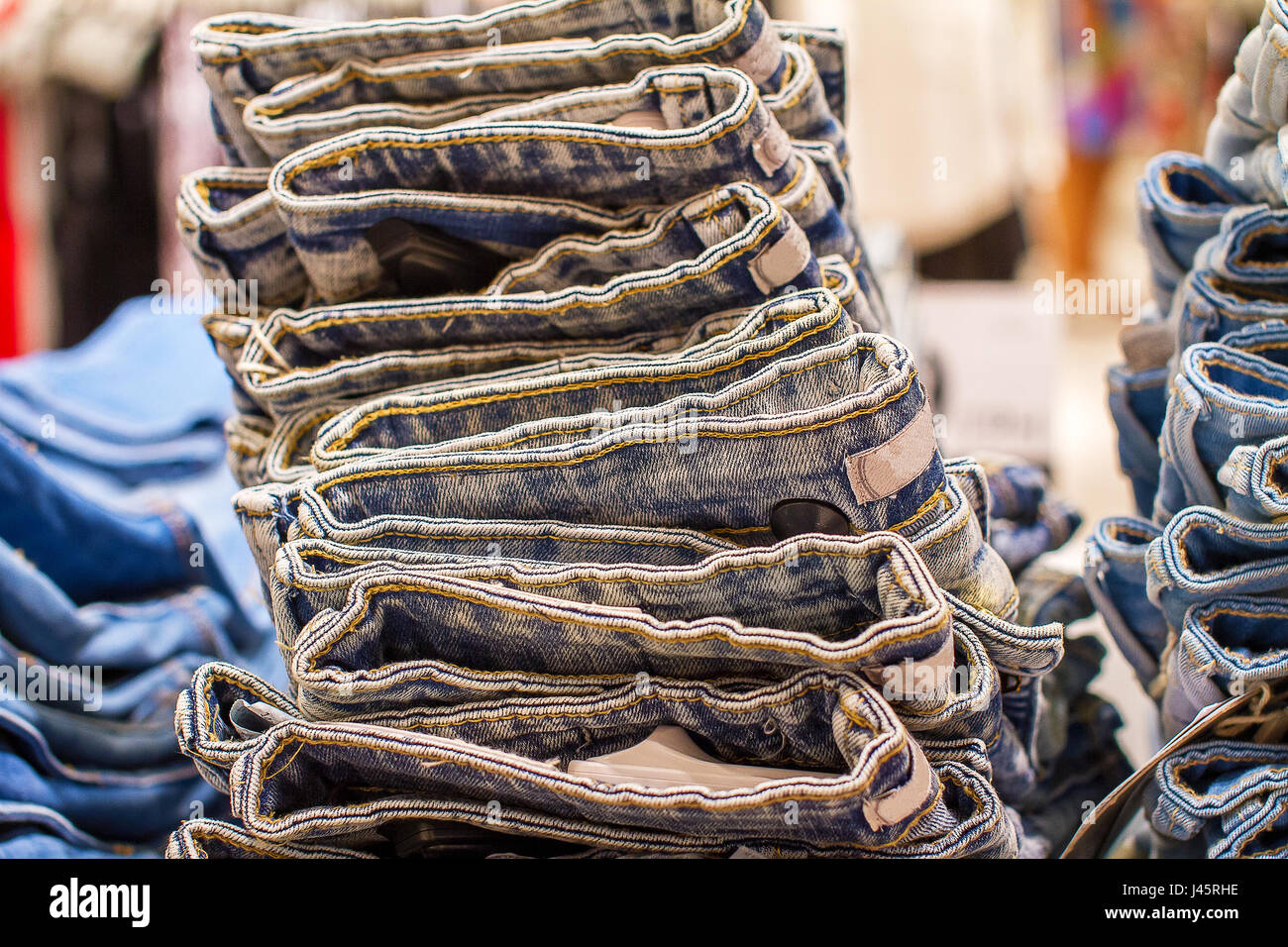image stack of folded jeans in the store Stock Photo - Alamy