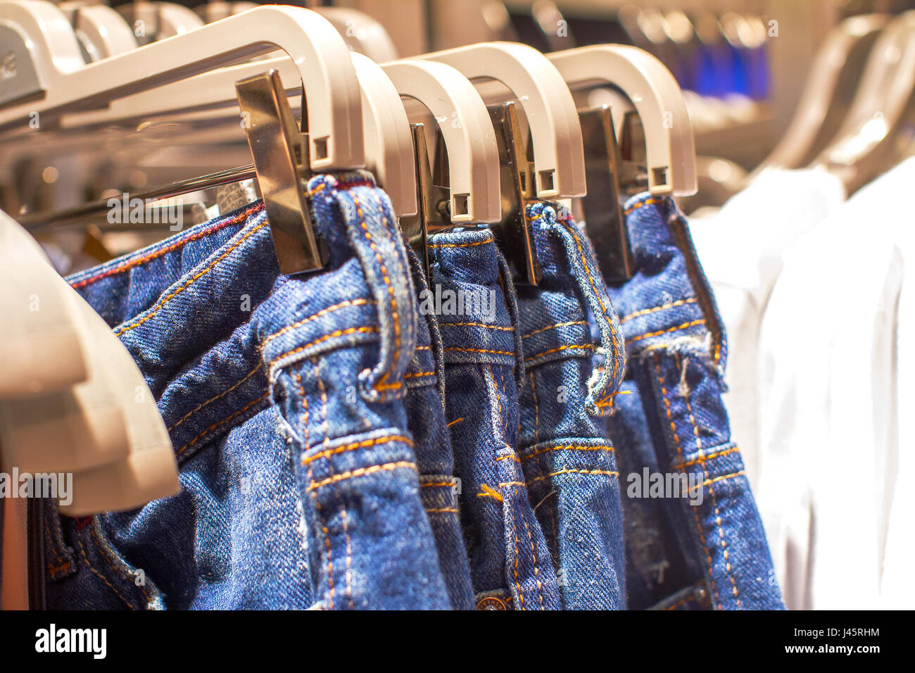 Denim jeans hanging on closet hi-res stock photography and images - Alamy