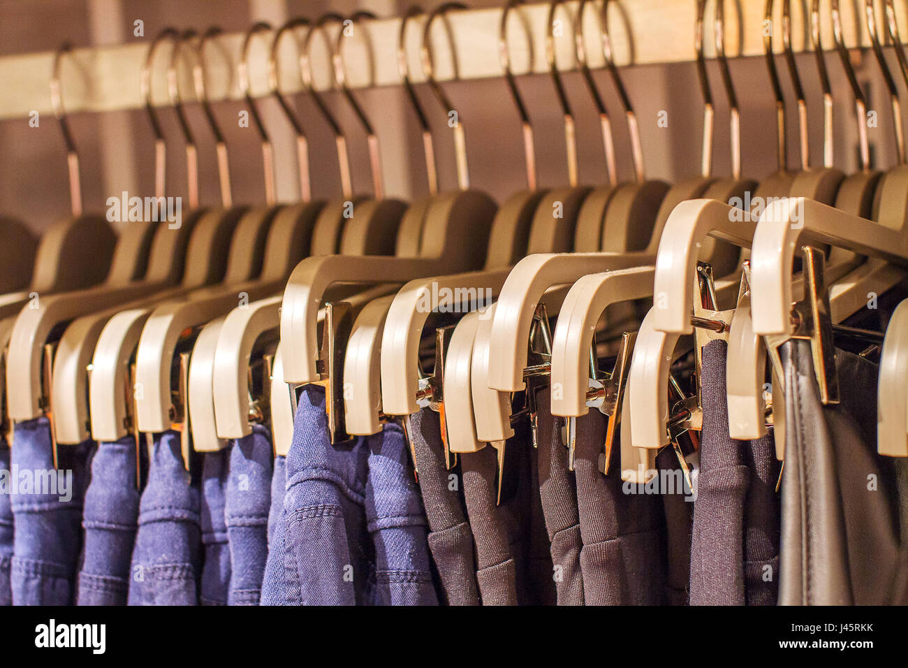 Denim jeans hanging on closet hi-res stock photography and images - Alamy