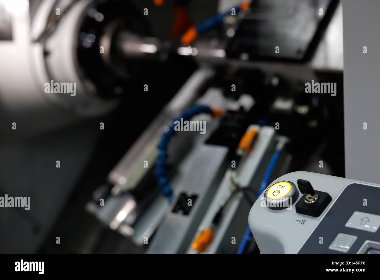 Close up of cnc turning lathe machine. Selective focus on OK push ...