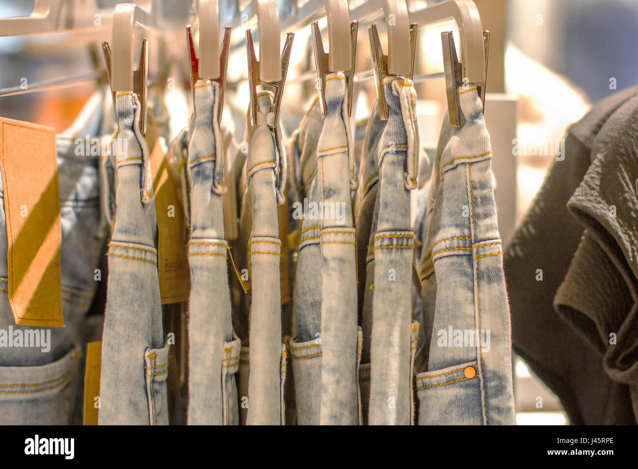 Denim jeans hanging on closet hi-res stock photography and images - Alamy