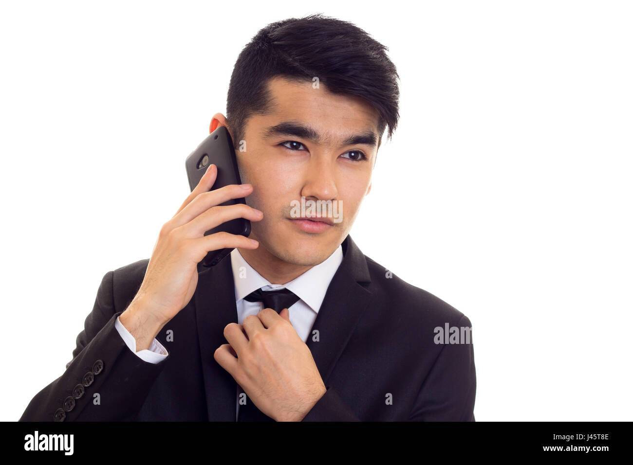 Young man in suit talking on the phone Stock Photo - Alamy