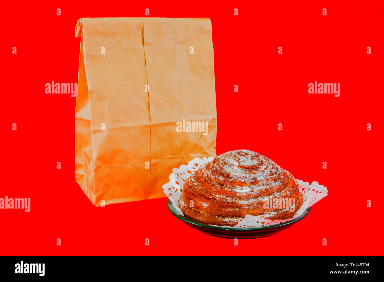 a paper bag with bun on a red background Stock Photo - Alamy