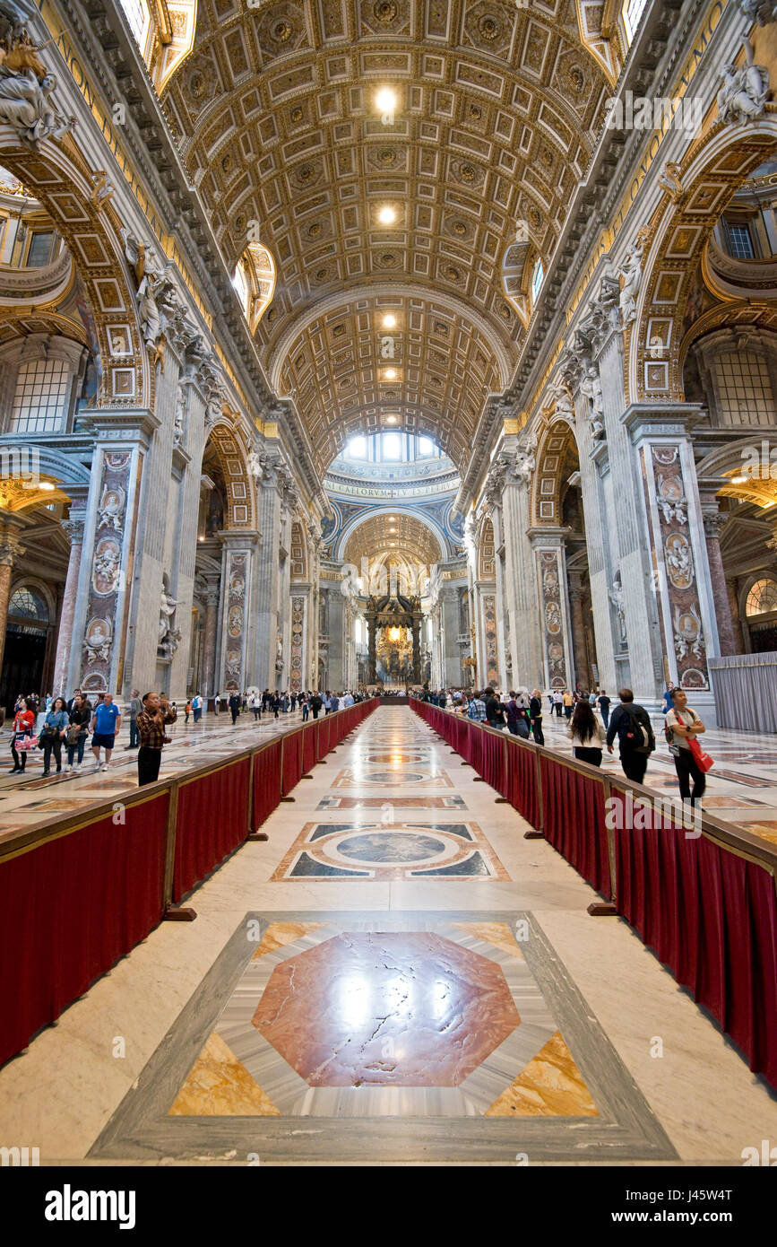 A wide angle interior view inside St Peter's Basilica with tourists walking around Stock Photo ...