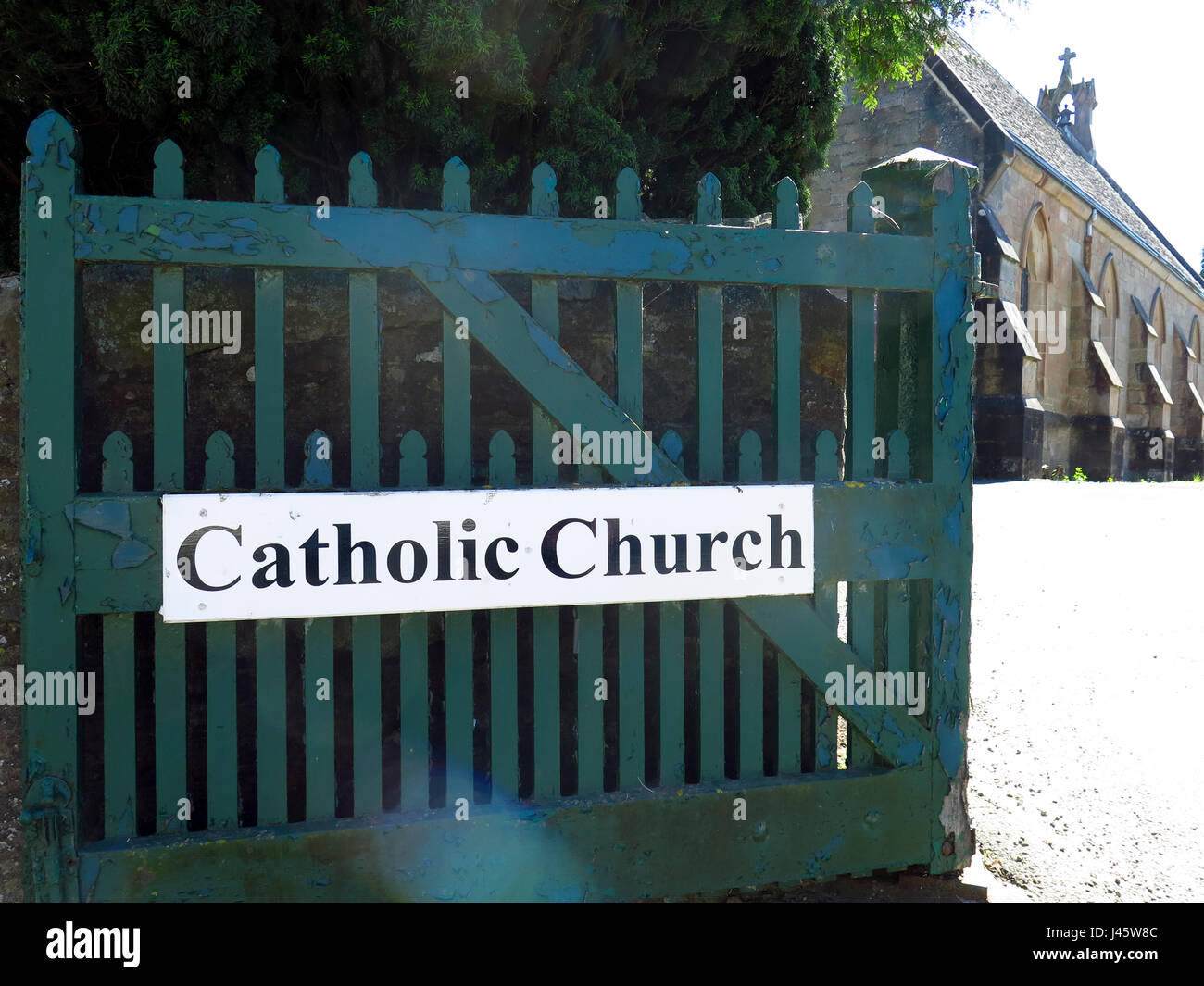 Gate with sign leading to Catholic Church Stock Photo - Alamy