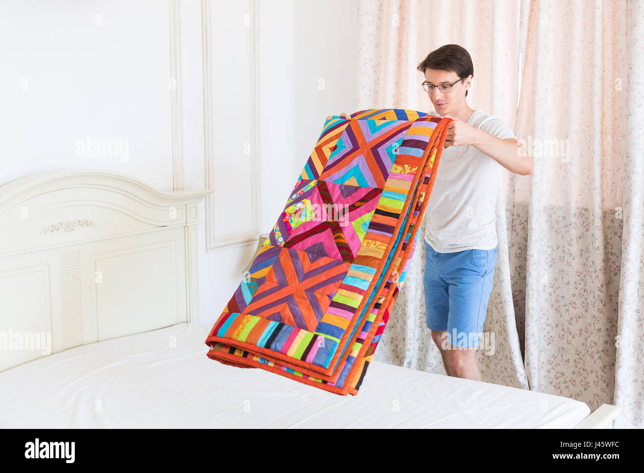 home cosiness, homecraft, patchwork, quilting, designe concept - handsome man in sky-blue shorts ...