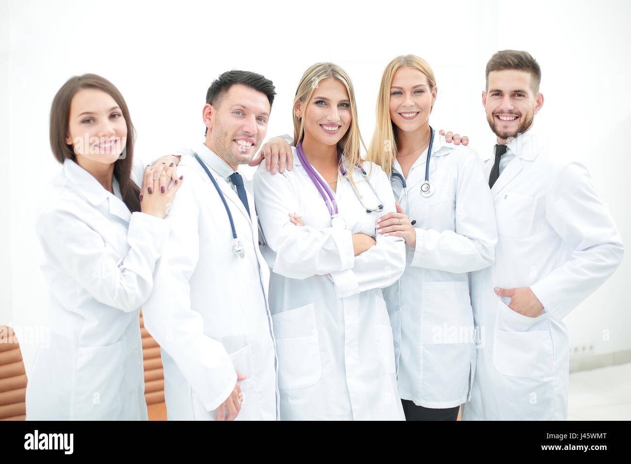 Happy and confident team of doctors posing on camera Stock Photo - Alamy