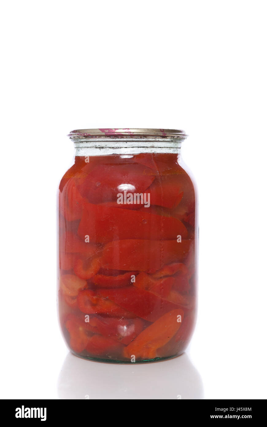 Canned red pepper in a glass jar on a white background Stock Photo - Alamy