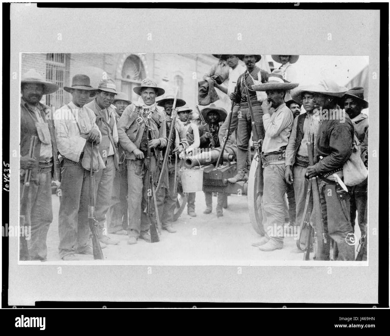 This image depicts a group of Mexican rebels with a cannon, emphasizing ...