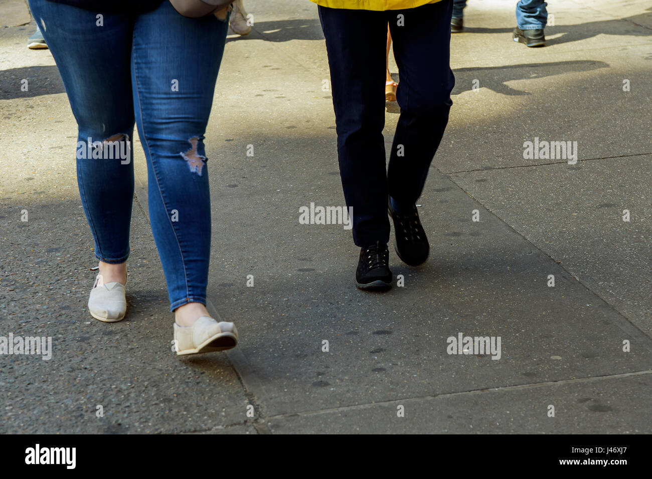 womens legs walking on a pedestrian crossing on a sunny daye Stock ...