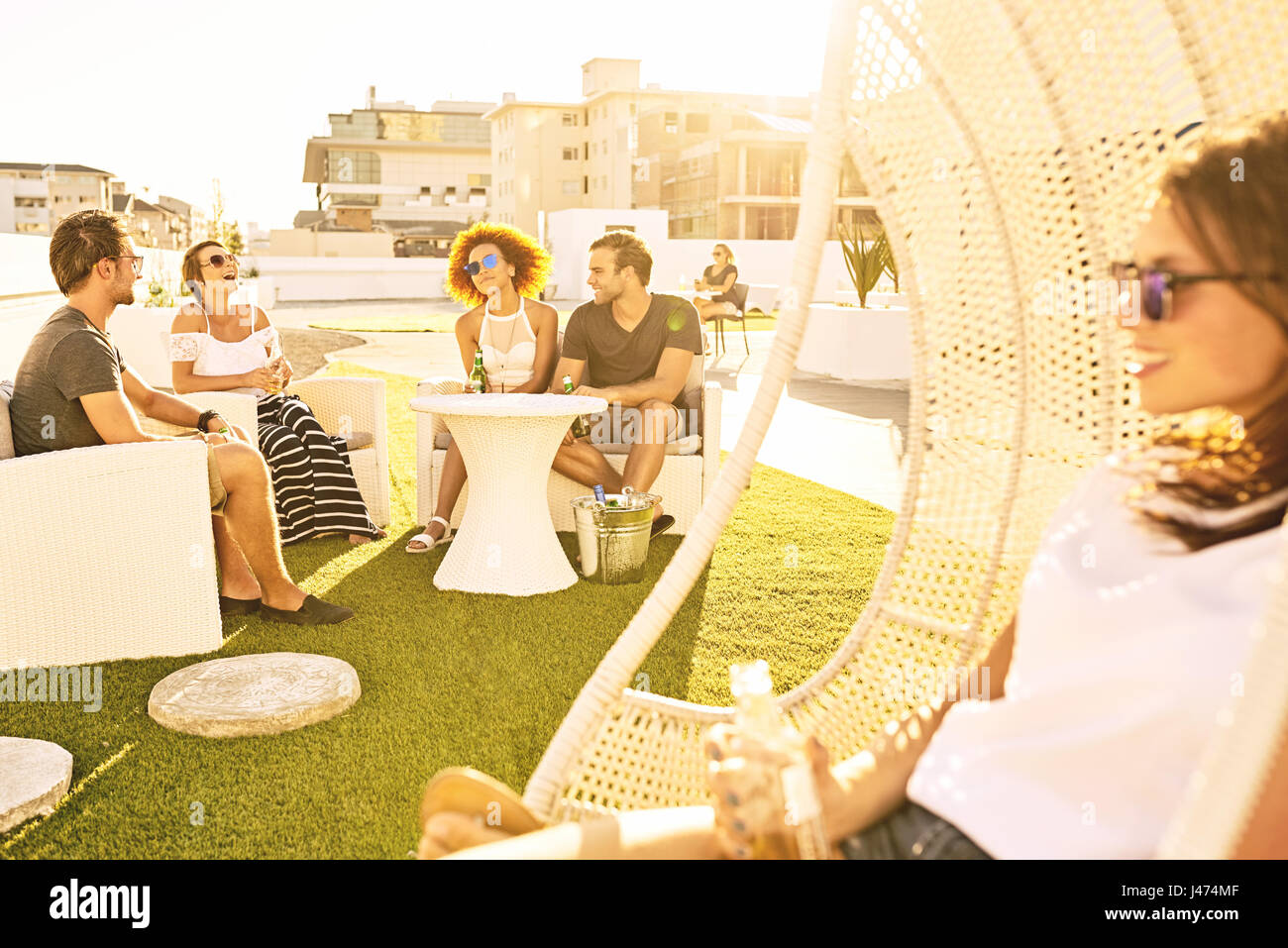 Beautiful young adults socialising together outdoors on an urban ...