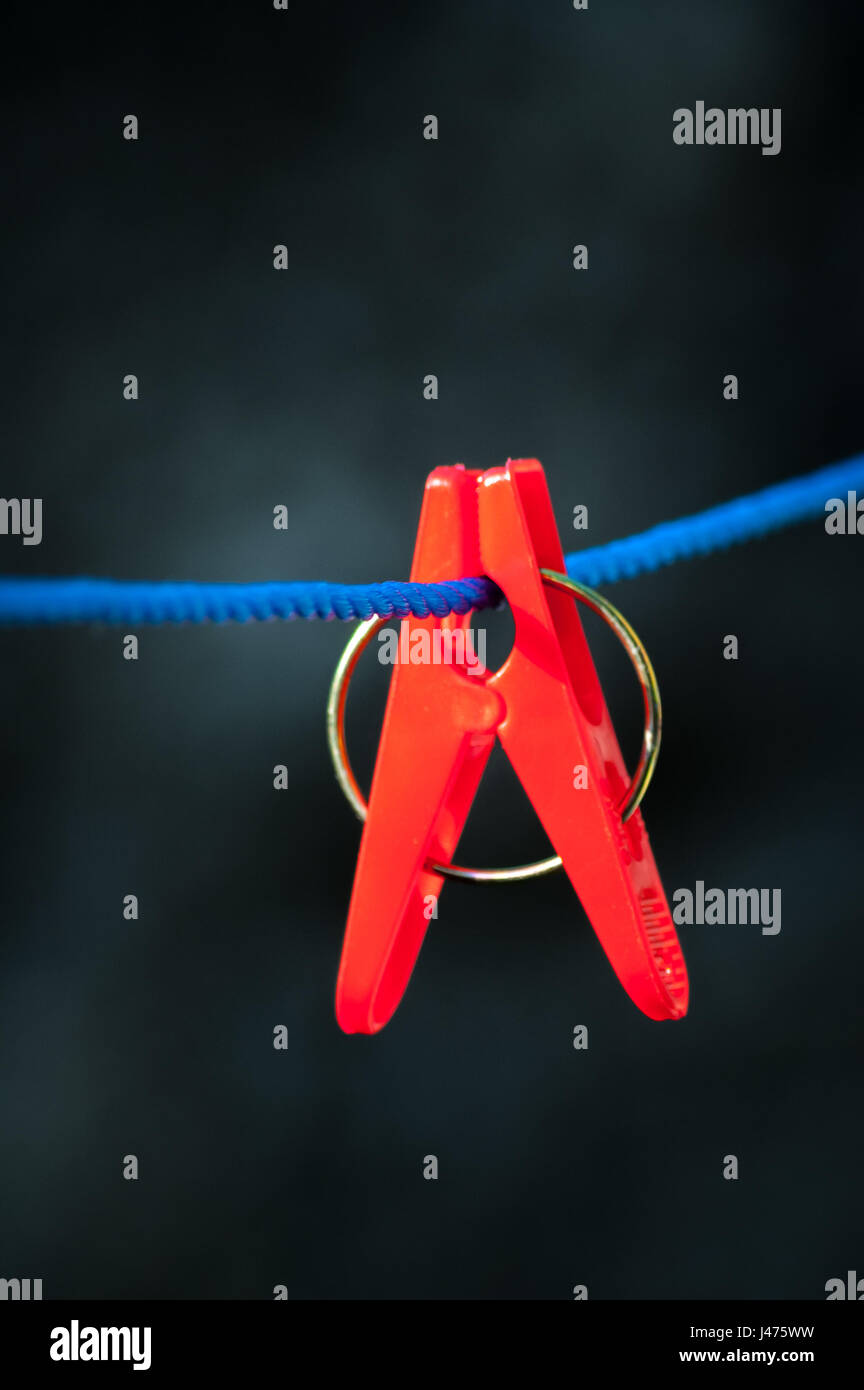 Plastic laundry clamp on clothesline Stock Photo - Alamy