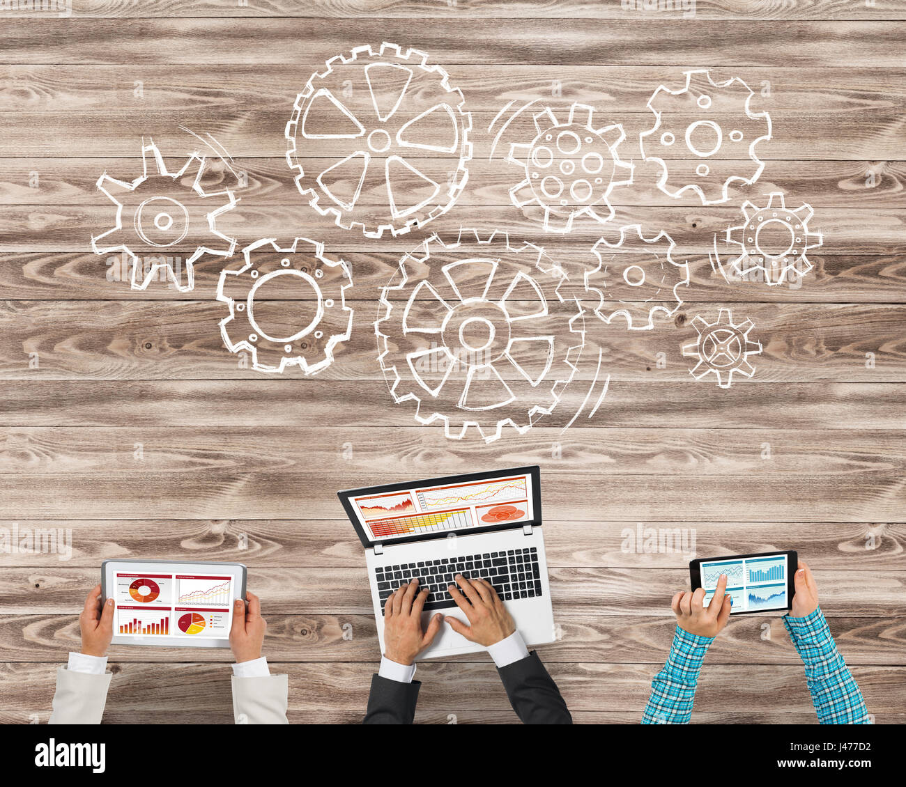 Group of three people with devices in hands working together as symbol ...