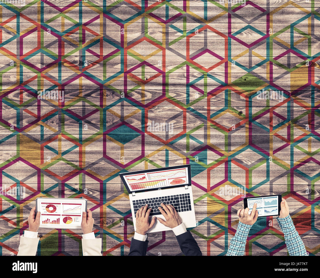 Group of three people with devices in hands working together as symbol ...