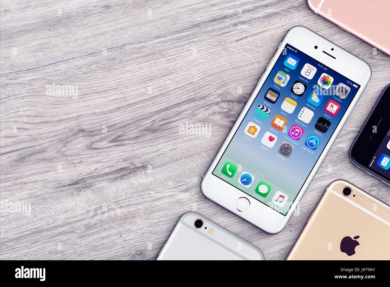 Set of multicolored Apple iPhones 6s flat lay top view lies on wooden ...
