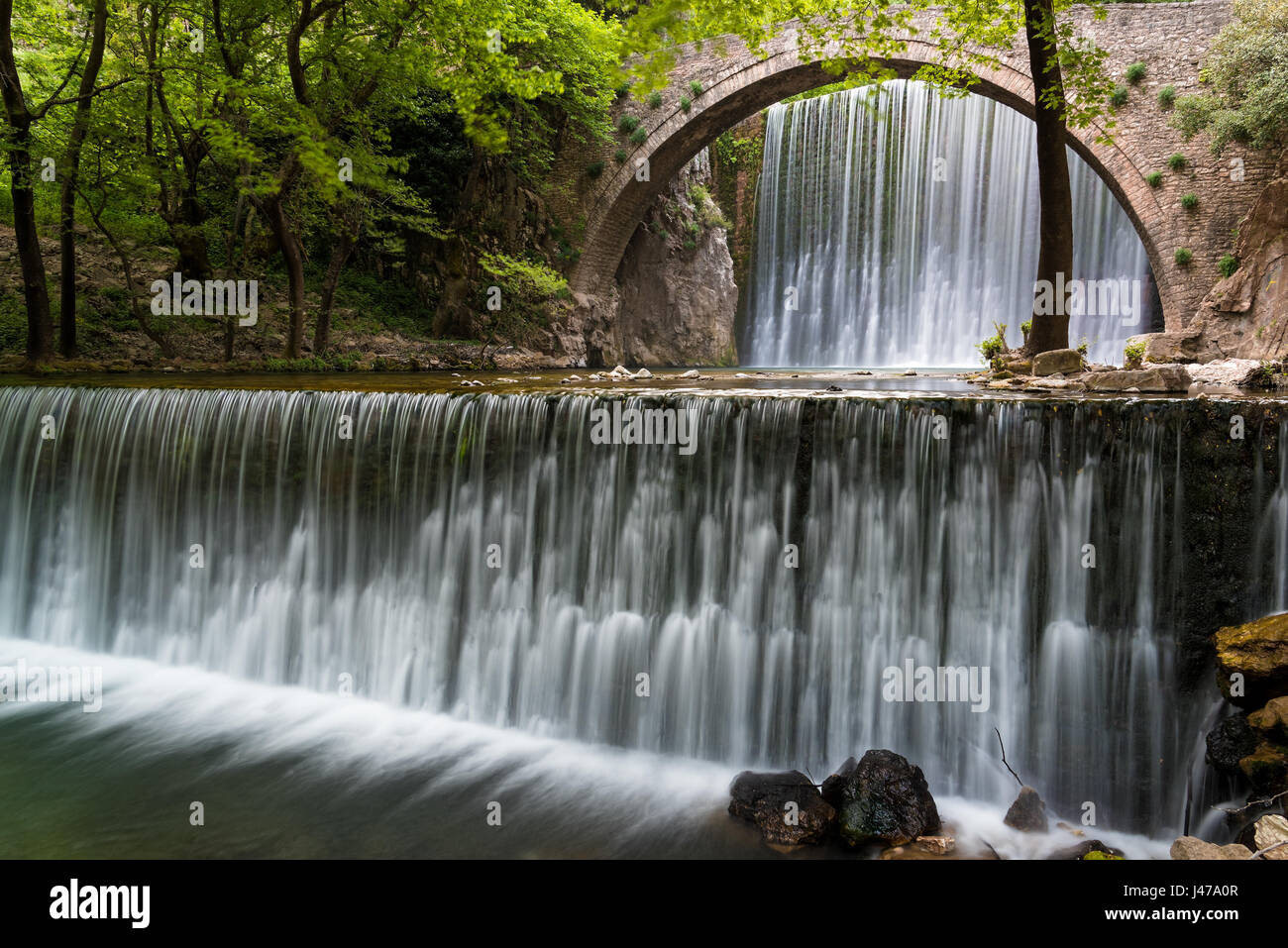 Traditional stone bridge and double waterfall near Paleokaria village ...